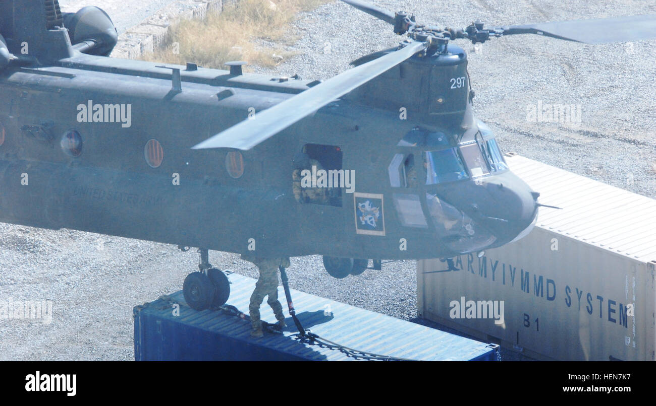 A crew chief directs the pilots of a 10th Combat Aviation Brigade CH-47 Chinook helicopter as it ...