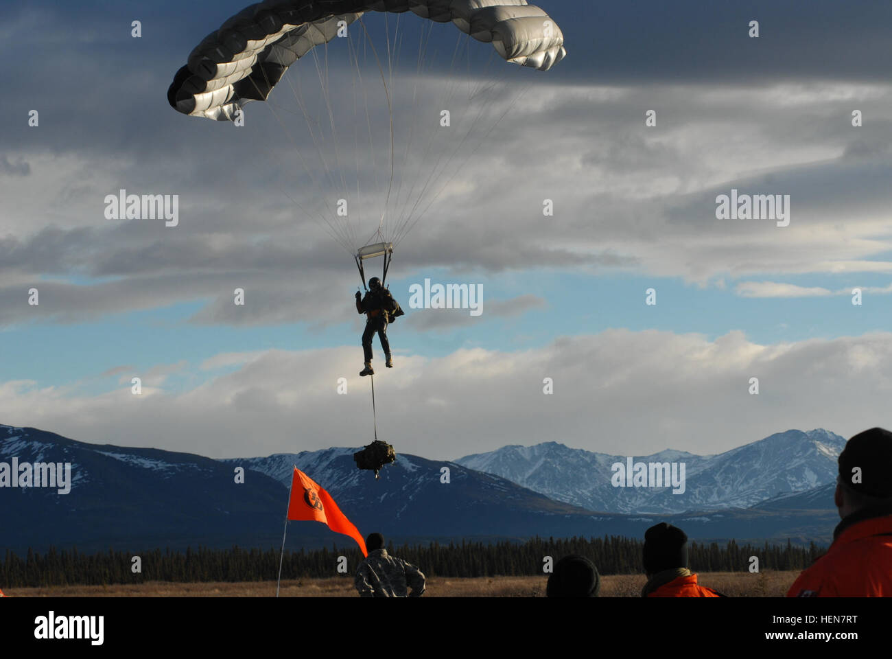 A pararescue jumper approaches the ground after jumping out of a plane ...