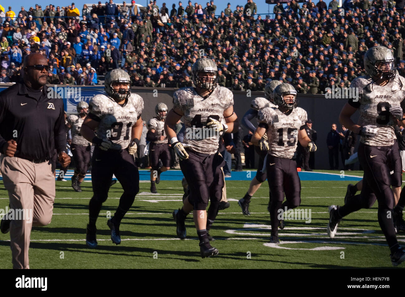 U.S. Army Black Knights football players run onto the field during a ...