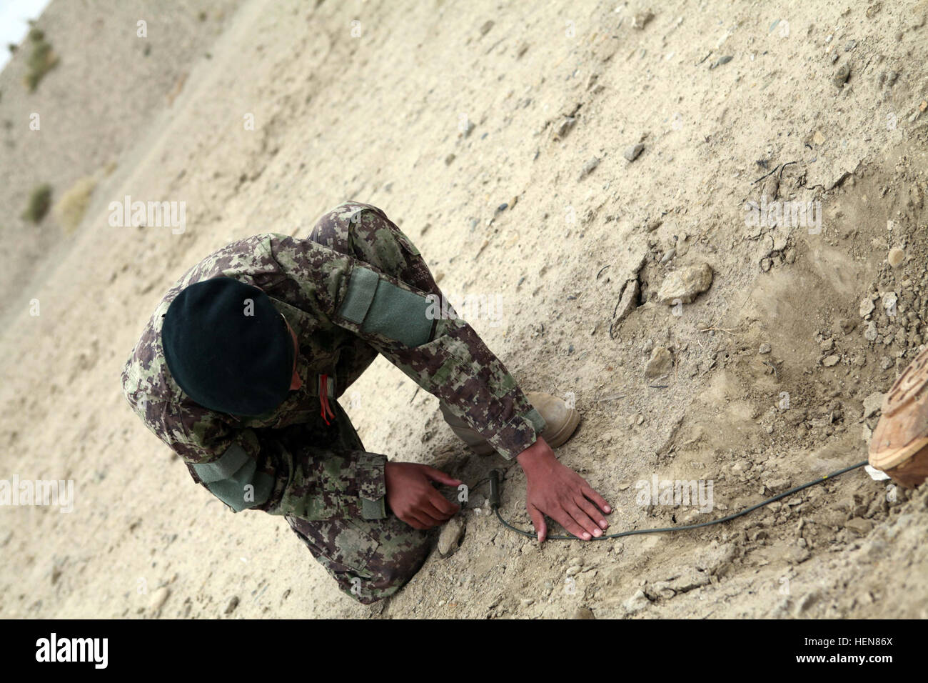An Afghan National Army (ANA) soldier measures the distance of a time ...
