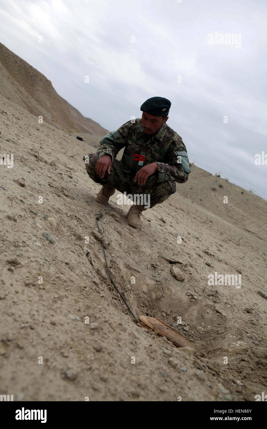 An Afghan National Army soldier examines his placement of a time fuse ...