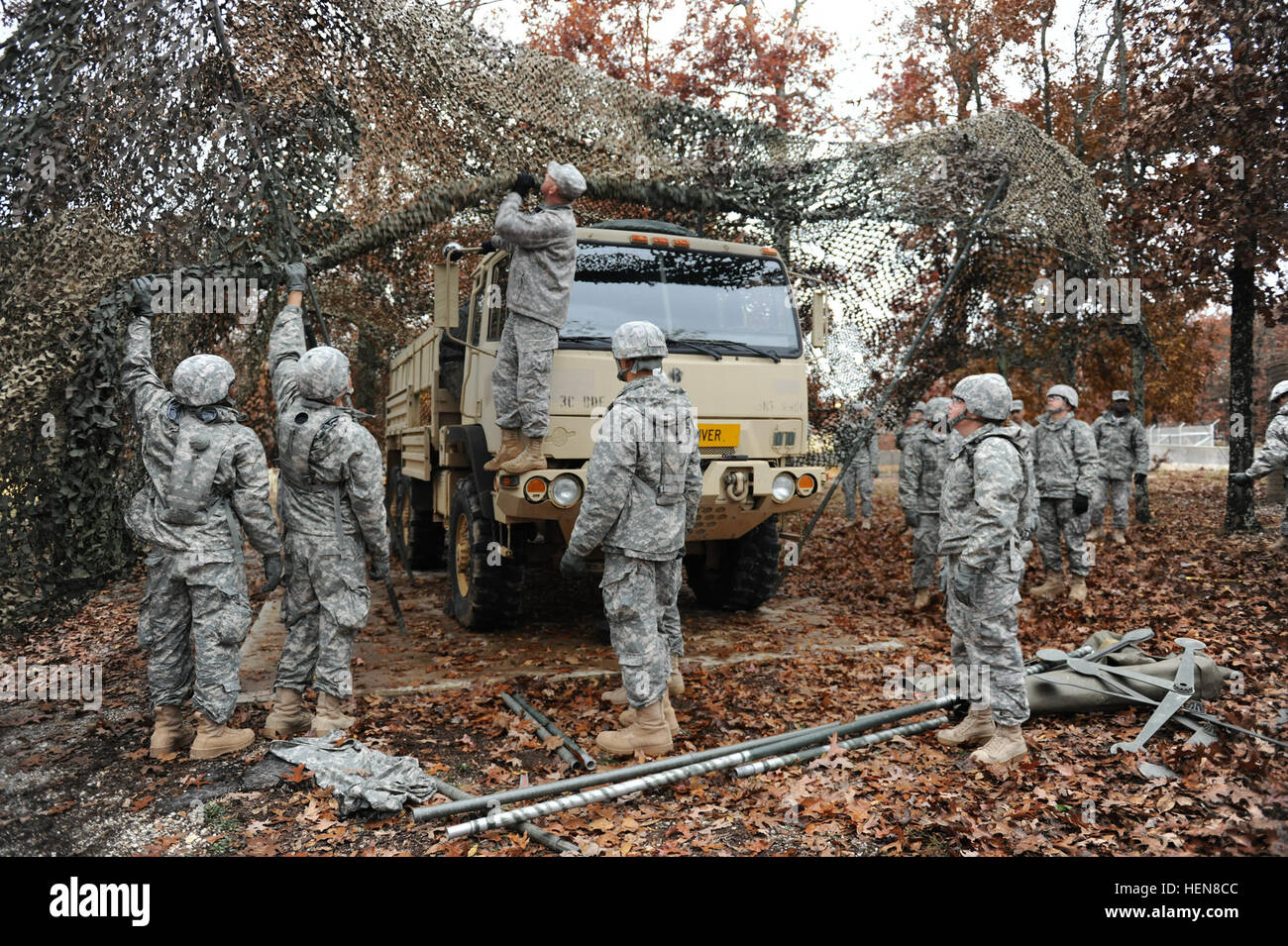 Soldiers from the 58th Transportation Battalion learn to camouflage a ...