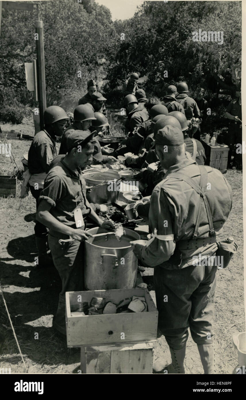 Soldiers at a Civil Affairs Staging Area field mess receive meals and ...