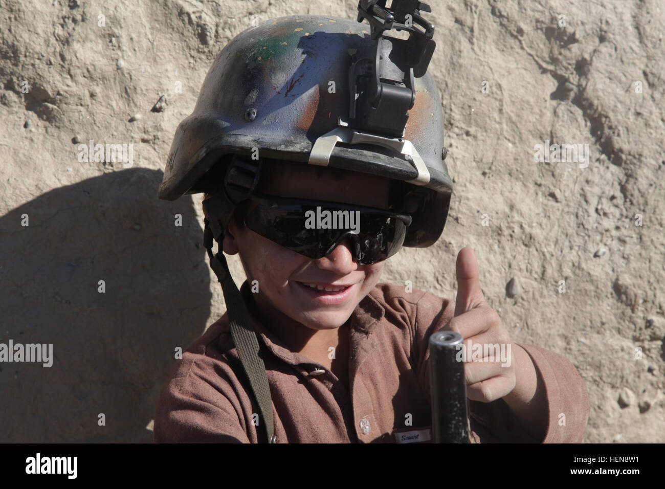 Afghan boy wears equipment as if he is a commando in Boti Kot district ...