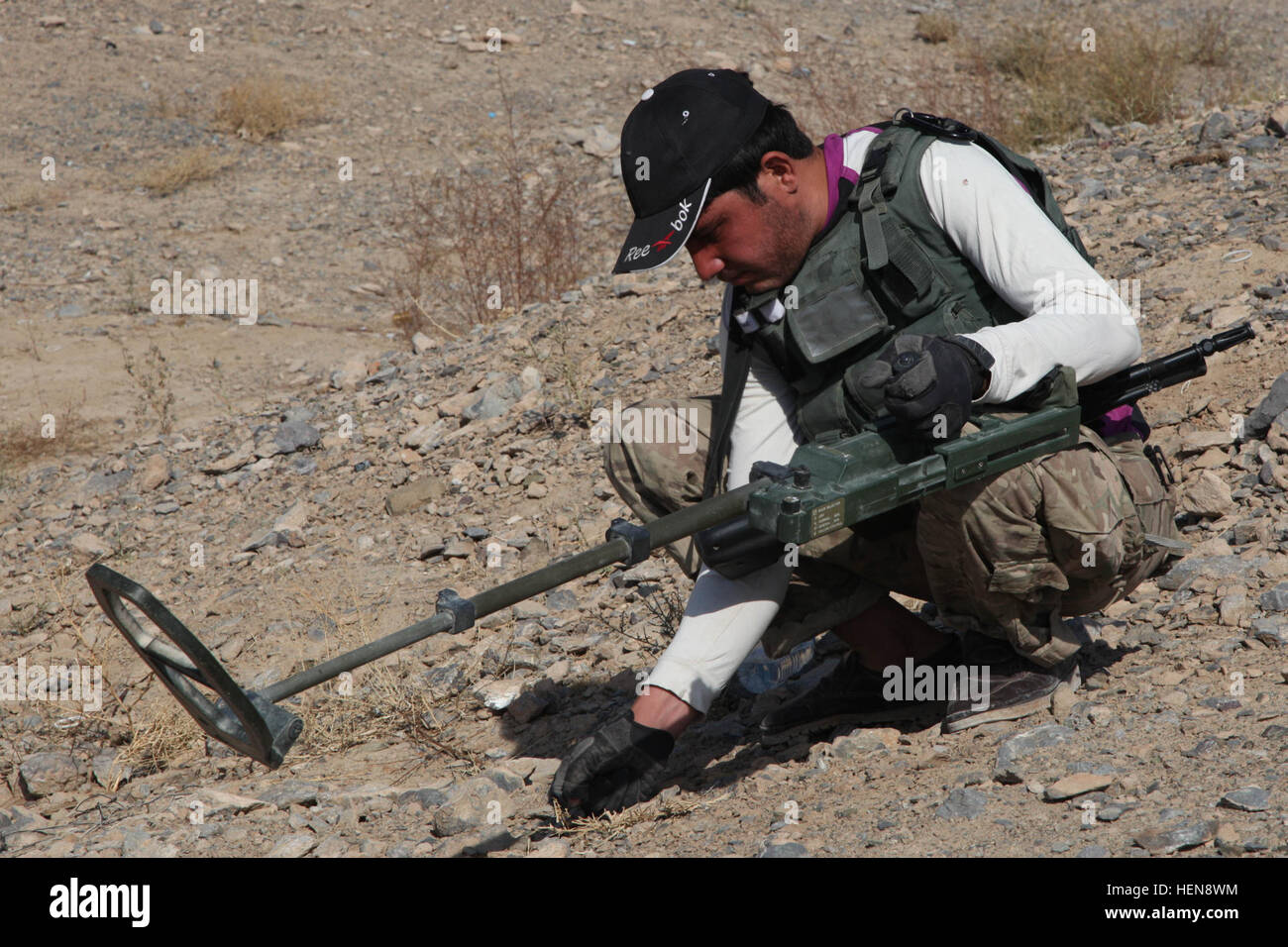 An Afghan Civilian Mine Removal Group (CMRG) member stops to ...