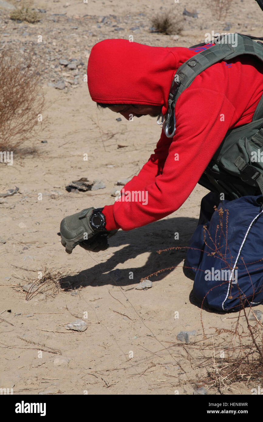 An Afghan Civilian Mine Removal Group (CMRG) member cuts a trip wire ...