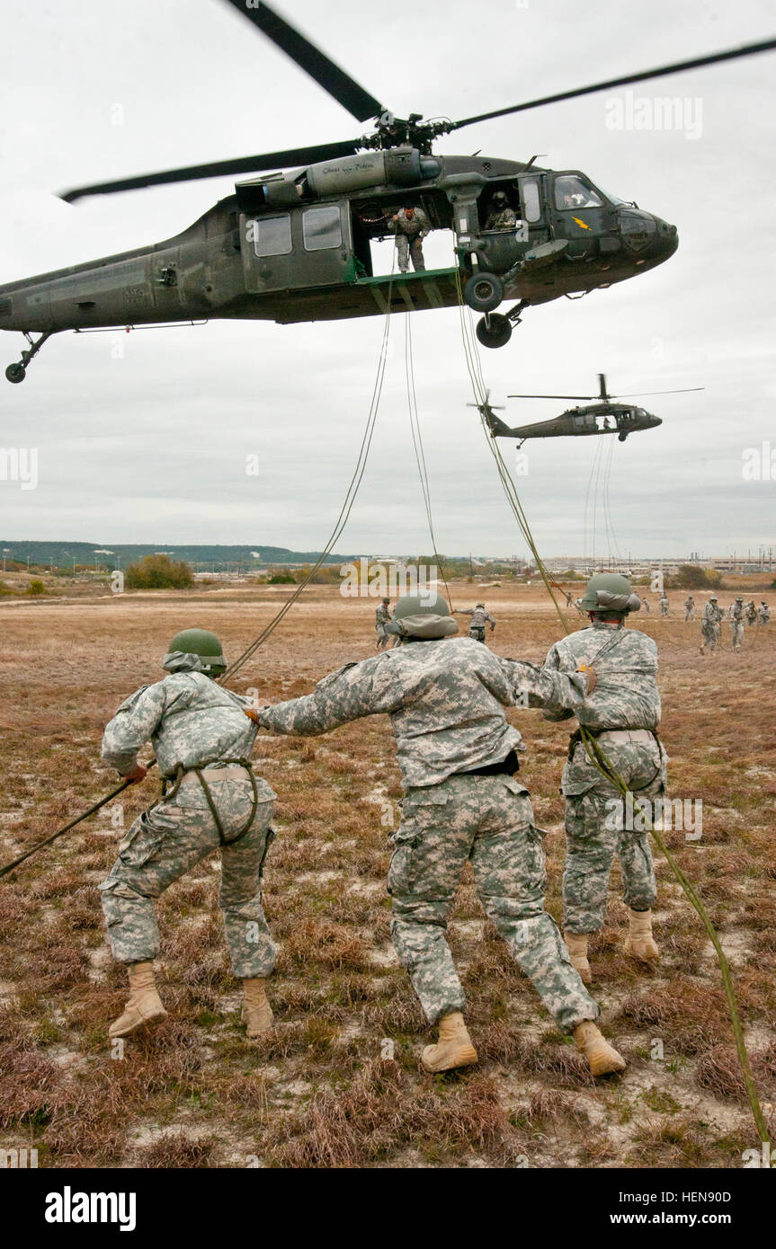 Fort Hood Air Assault instructor Sgt. Anthony Eashman (center), from ...