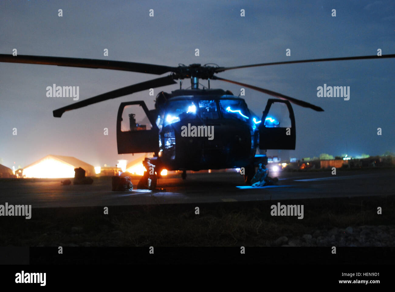 A prolonged exposure shows streaks of light from the headlamps of a ...