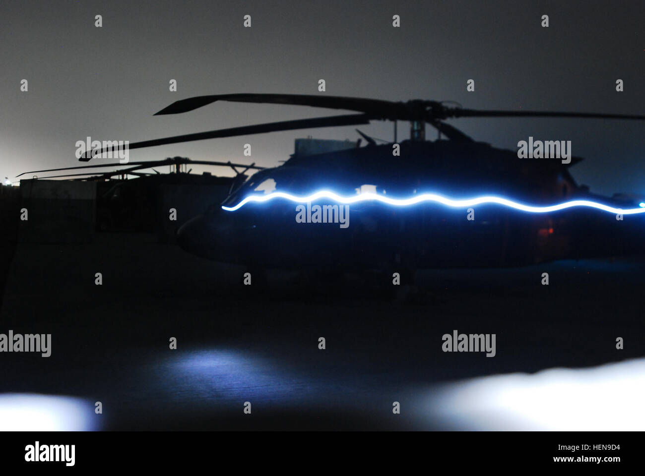 A prolonged exposure shows a streak of light from the headlamp of a ...