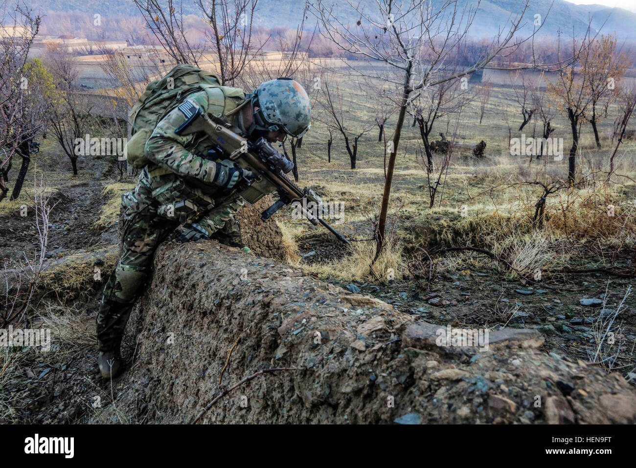 A U.S. Special Forces soldier climbs over a short wall during a ...