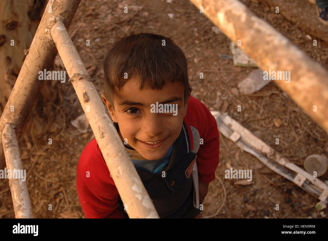 A Iraqi boy waits to be seen by U.S. Army Combat Medic from Troop A ...