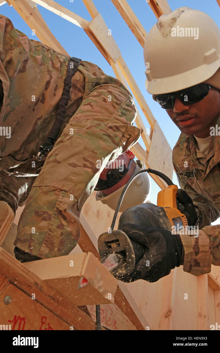 U.S. Army Spc. Mikhail George, left, puts pressure on a 2x4 while Spc ...