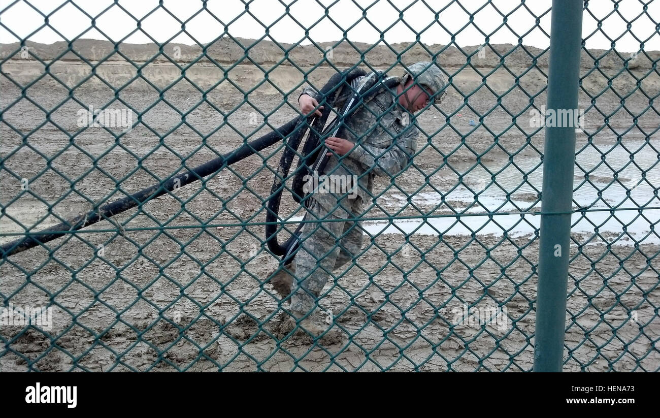 An engineer soldier from the 19th Engineer Battalion removes excess ...