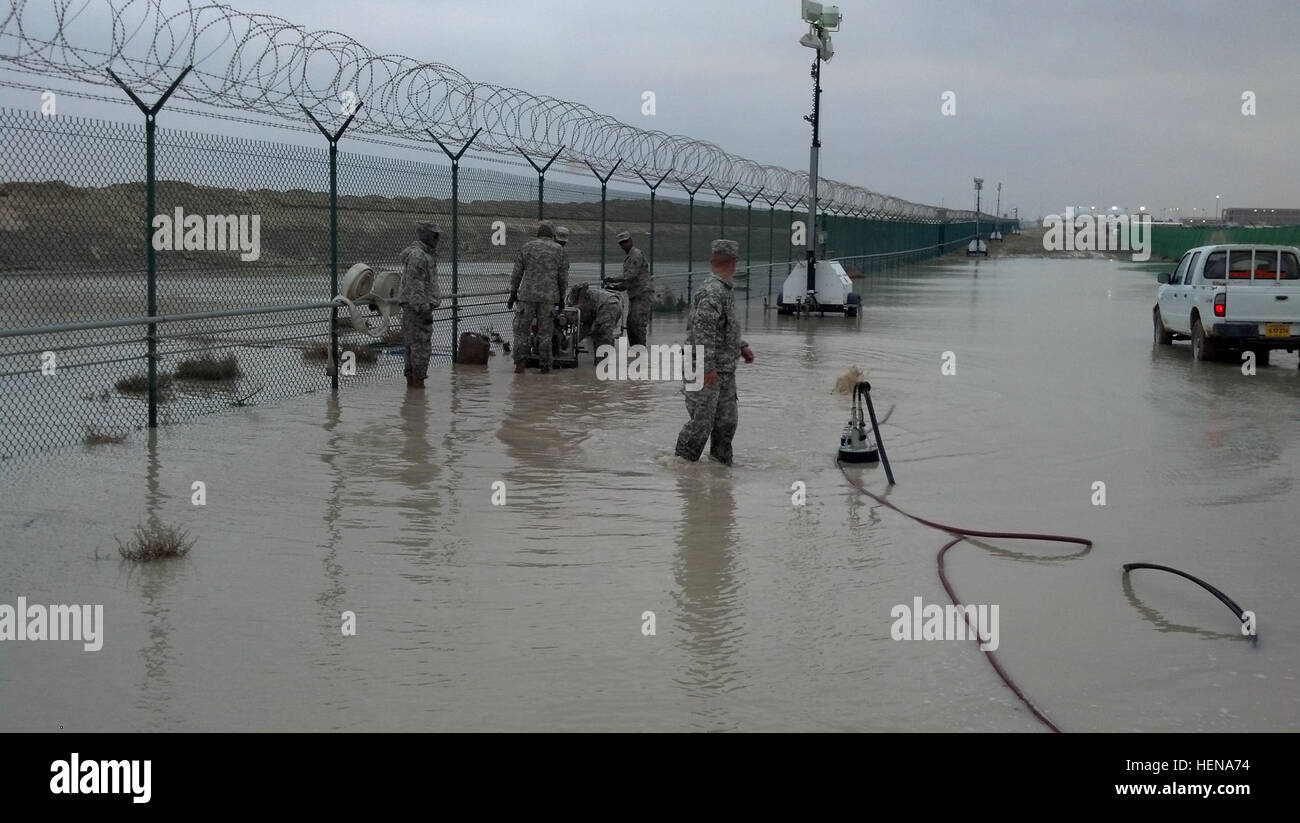 Engineers from the 19th Engineer Battalion work to drain excess water ...