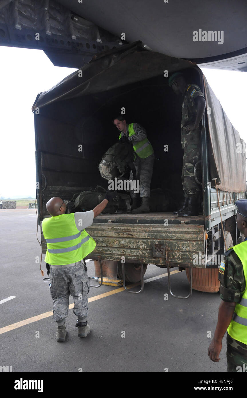 U.S. Airmen prepare to load Rwanda Defense Force equipment onto a U.S ...