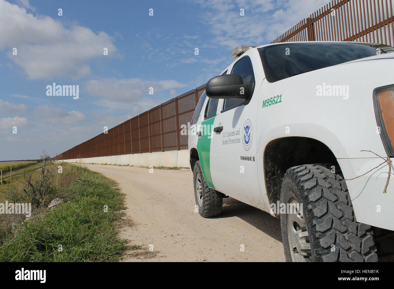 A U.S. Customs and Border Protection vehicle stands watch by one of the ...