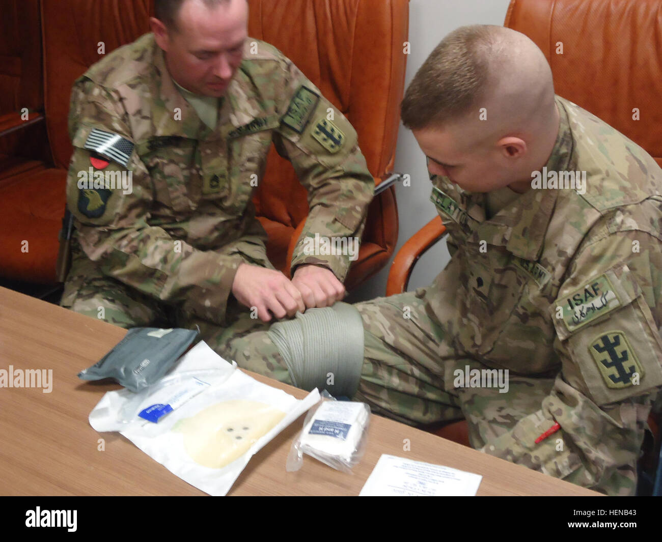 Sgt. 1st Class Eric Perry (left), JTF Sapper Operations NCO, places a ...