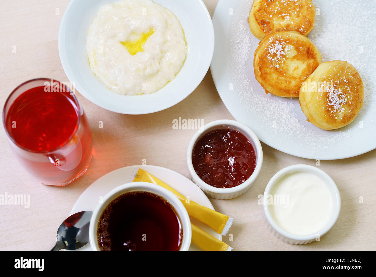 Breakfast table with porridge and cheese pancakes Stock Photo - Alamy