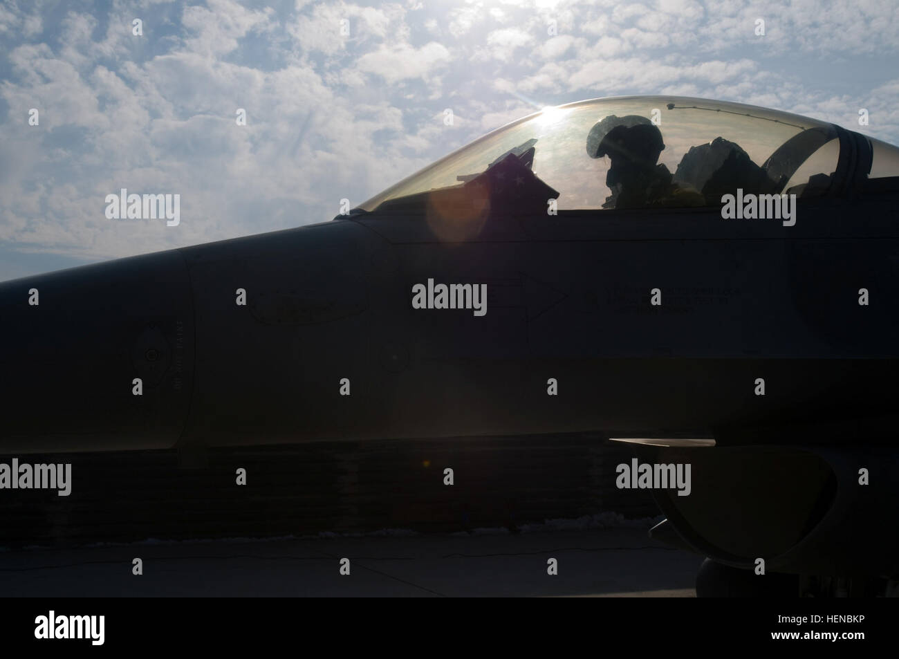 A folded American flag rests in the canopy of an F-16 fighter jet ...