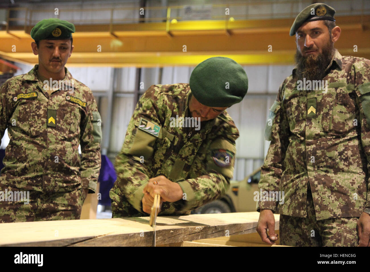 Afghan National Army soldiers of the 203rd Corps cut pieces of wood at ...