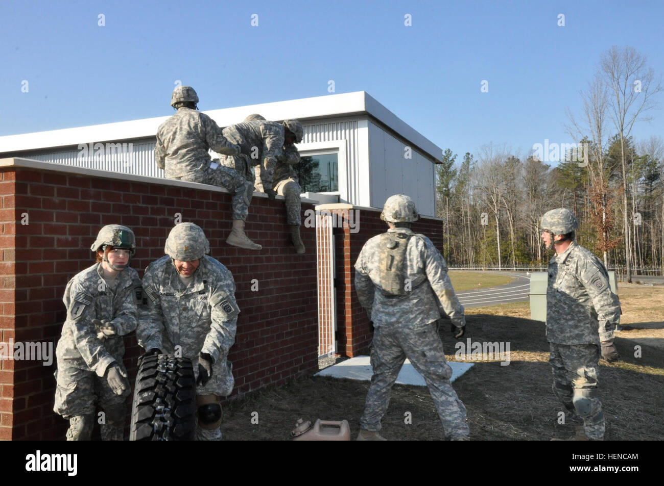 U.S. Army soldiers from the 82nd Airborne Division negotiate a wall ...