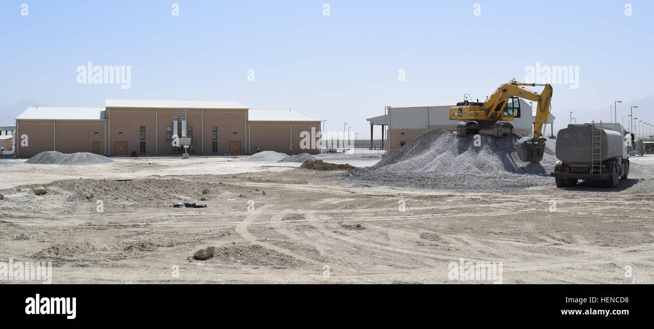 A backhoe distributes gravel across the new Waste Management Complex ...