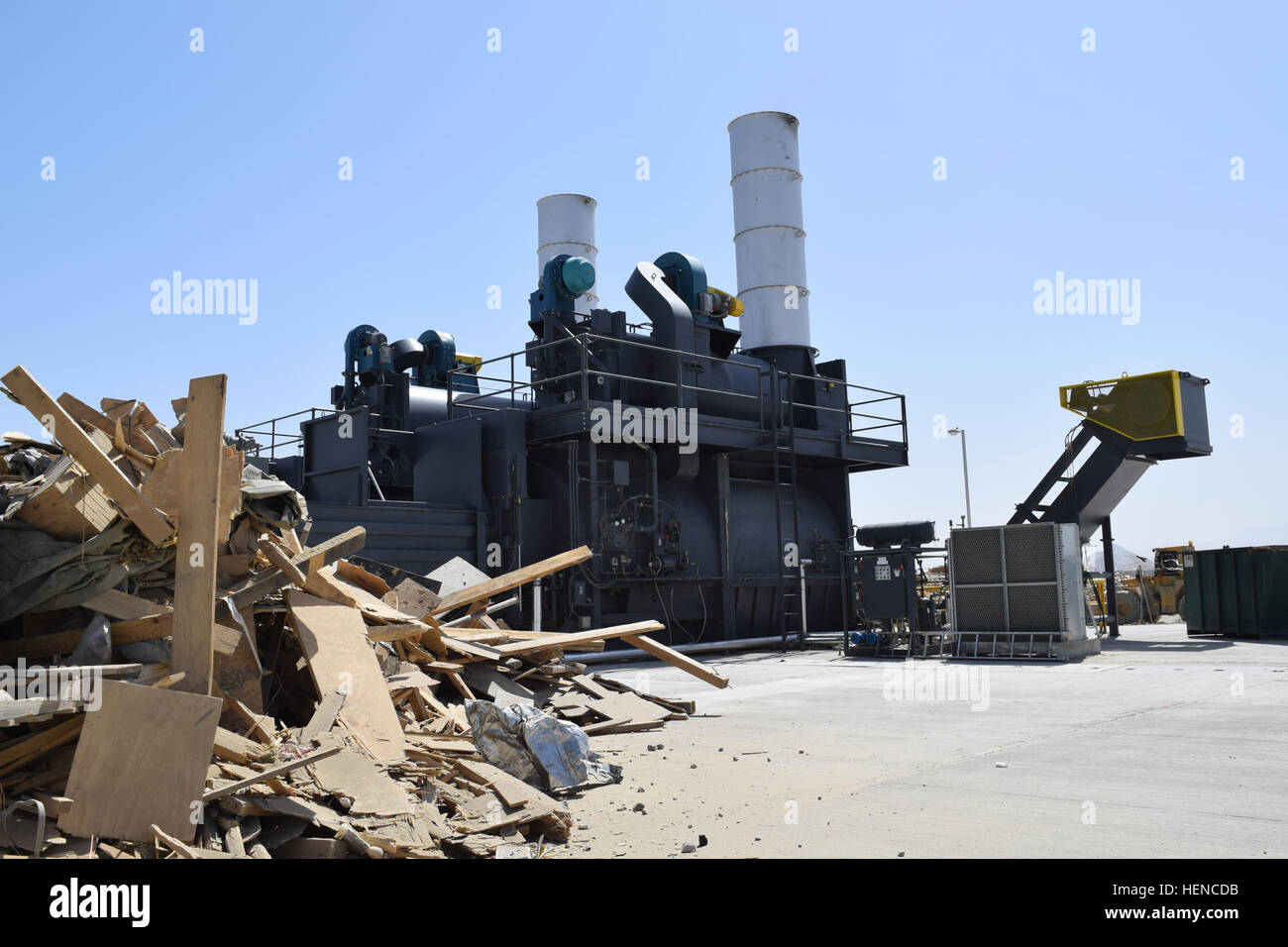 Combustible trash sits next to two of the new trash incinerators at the ...