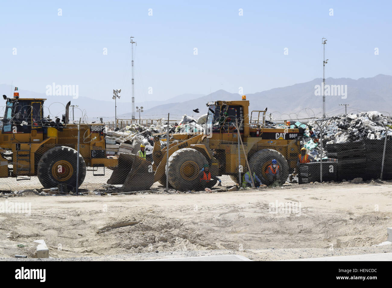 Afghan workers use front-end loaders to sort trash outside the new ...