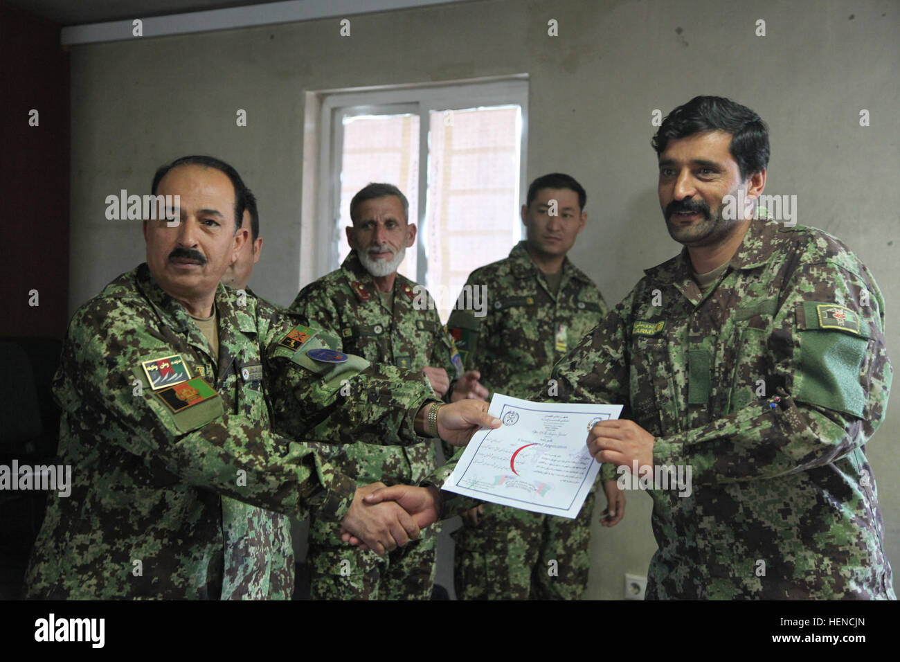 An Afghan National Army soldier with the 203rd Corps receives his ...