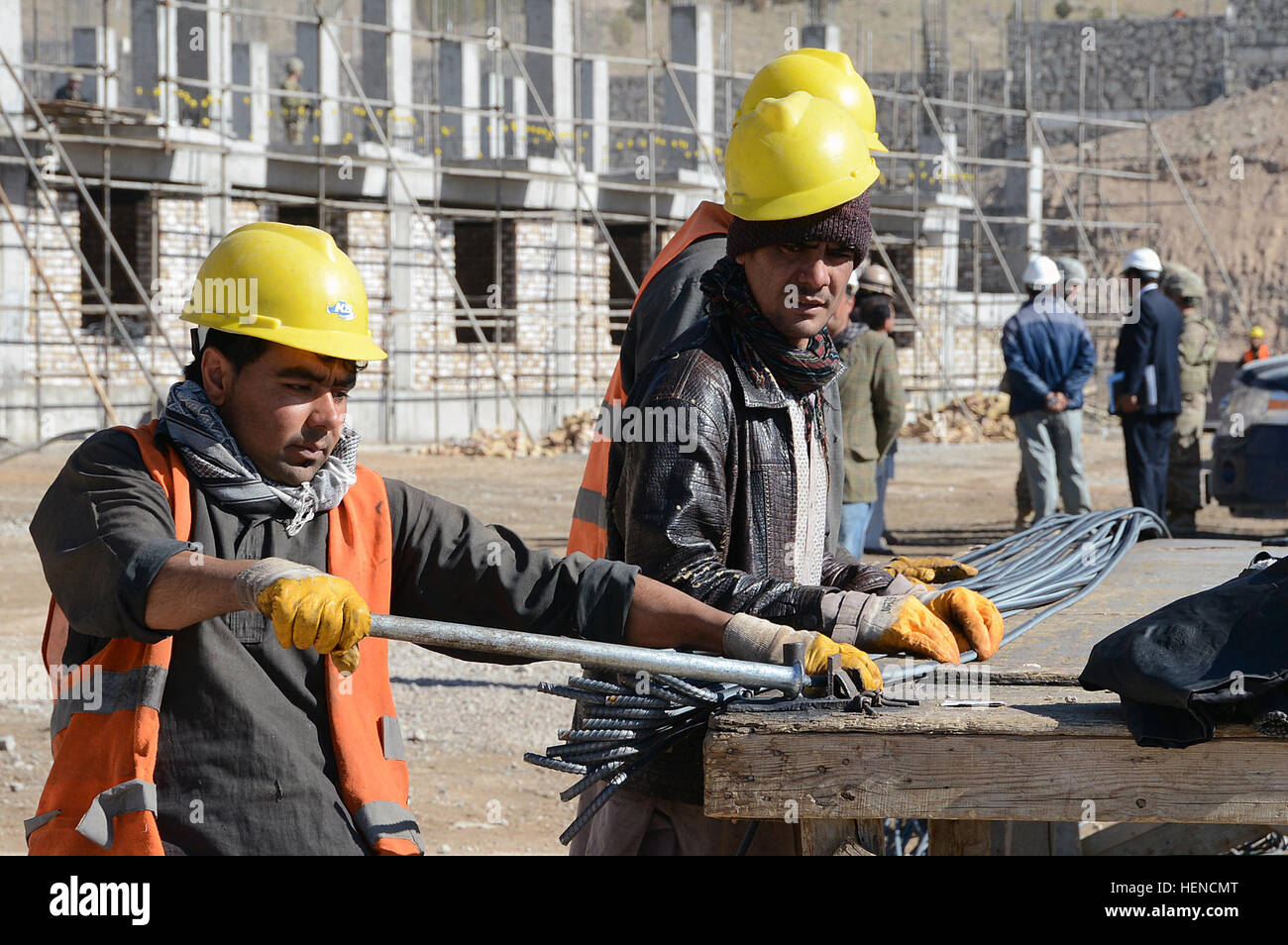 Workers bend reinforcing bar, or rebar, to strengthen concrete for a ...
