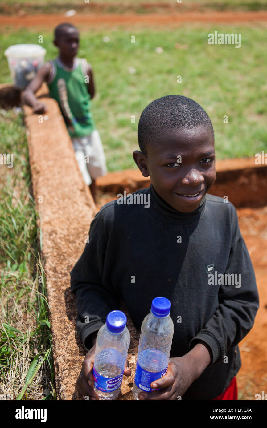 Cameroonian boys pause in their daily routine to observe the events ...