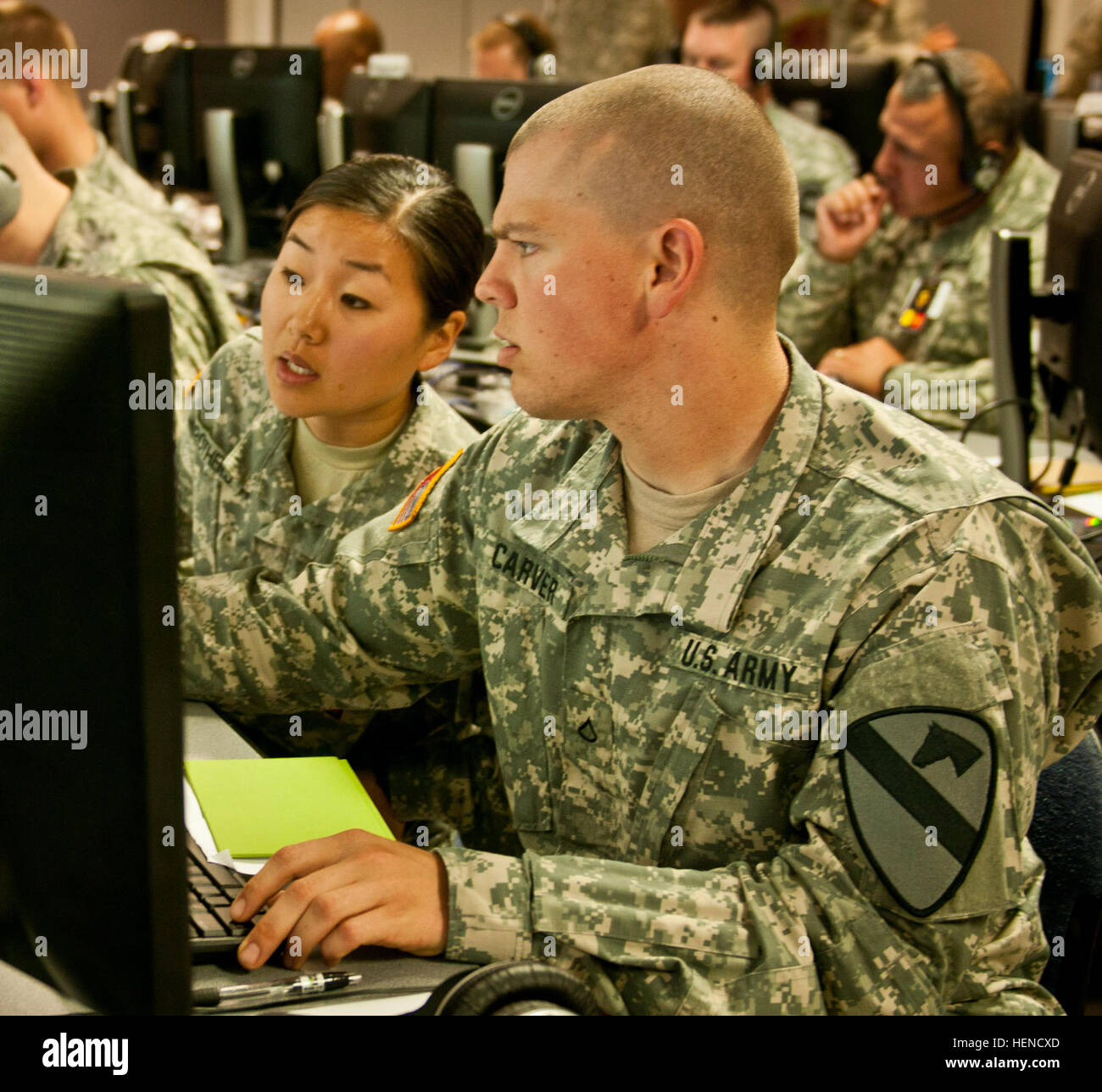 U.S. Army Pfc. Taylor Carver, from Corona, Calif., confers with 2nd Lt ...