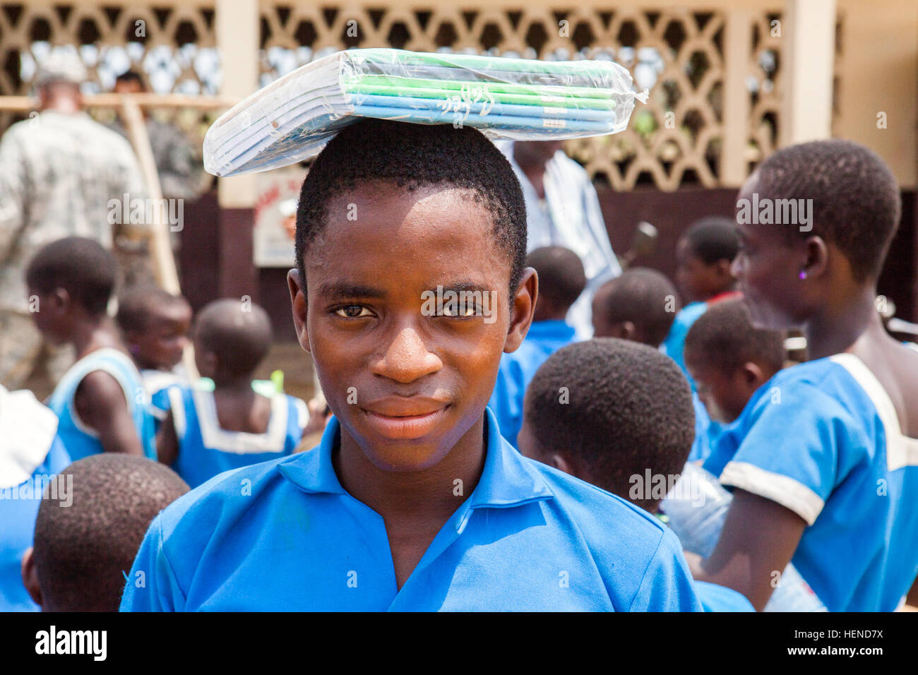 A Cameroonian boy balances his new school supplies given to him by U.S ...
