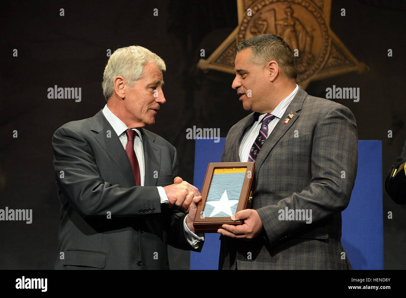 Secretary of Defense Chuck Hagel, left, presents the Medal of Honor ...