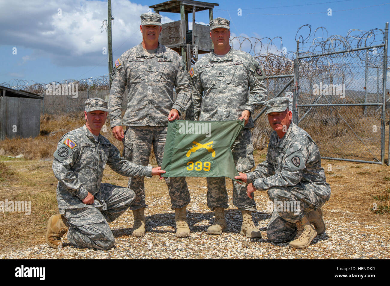 Members of the 339th Military Police Company, pose with their guidon at ...