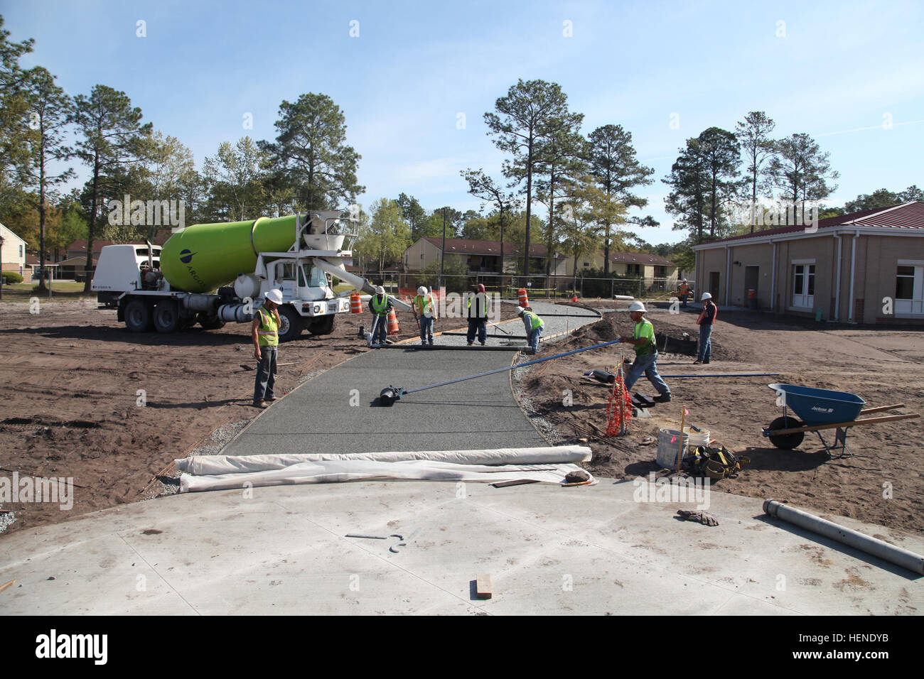 Workers build sidewalks at the new Murray Elementary School using ...