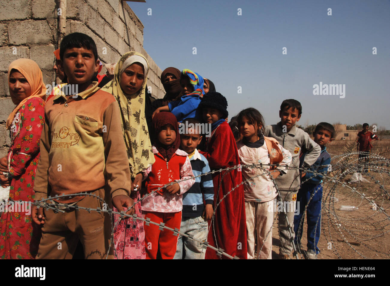 Local citizens from the Janabi village wait there turn to gather goods ...