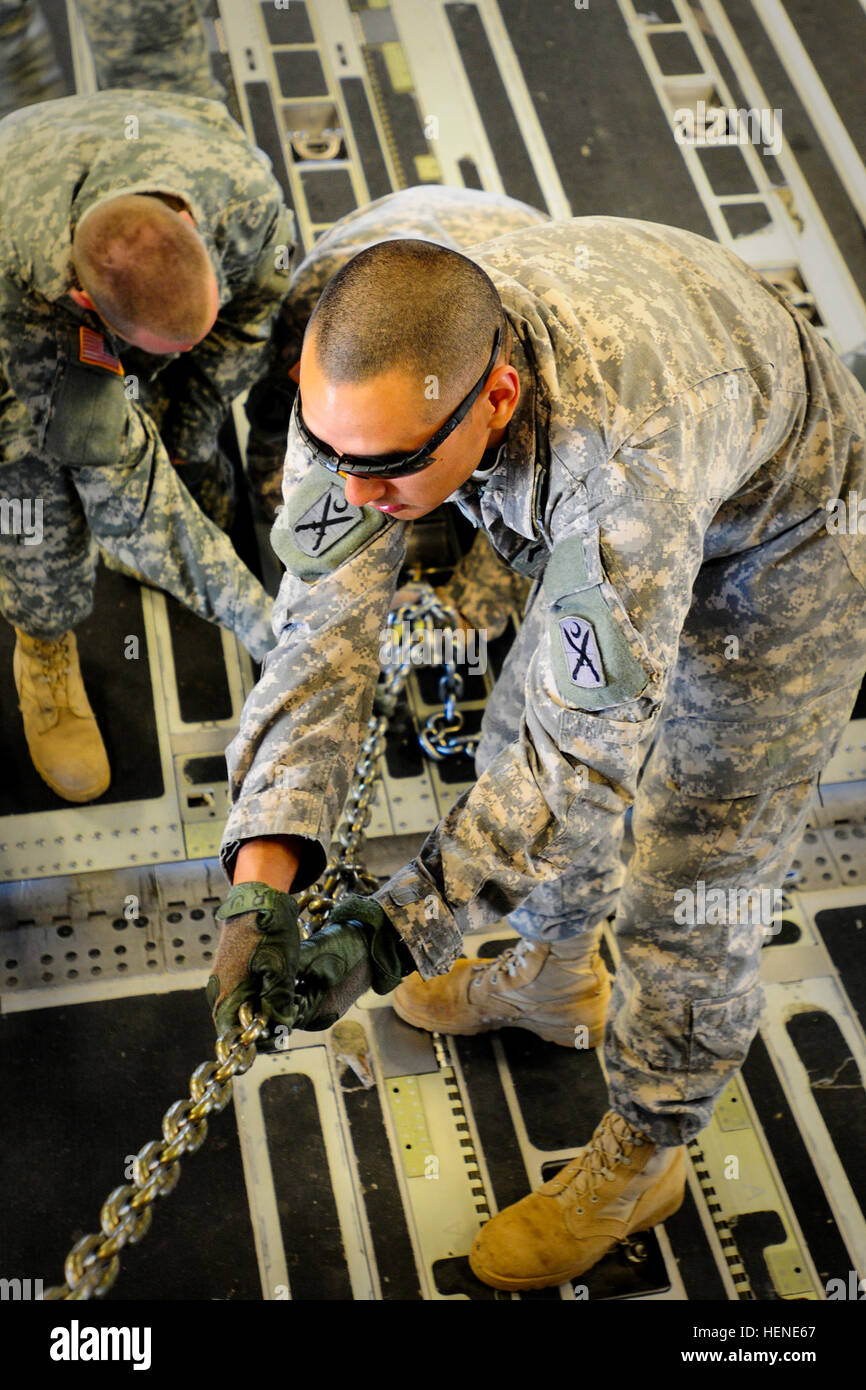 U.S. Army Sgt. Rudy Uribe, M1 Armor crewman, secures a M1A1SA Abrams ...