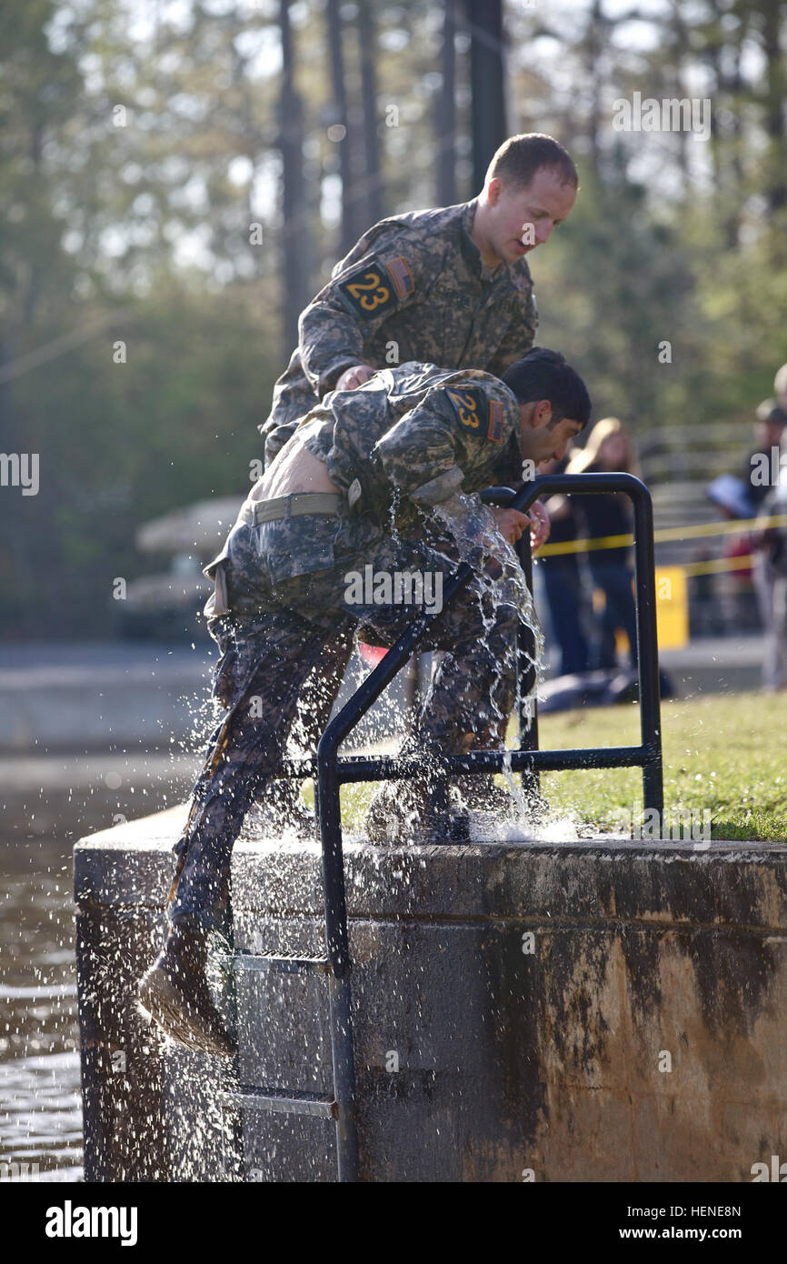 U.S. Army 1st Lt. Gregory Scheffler helps Staff Sgt. Adam Davila ...