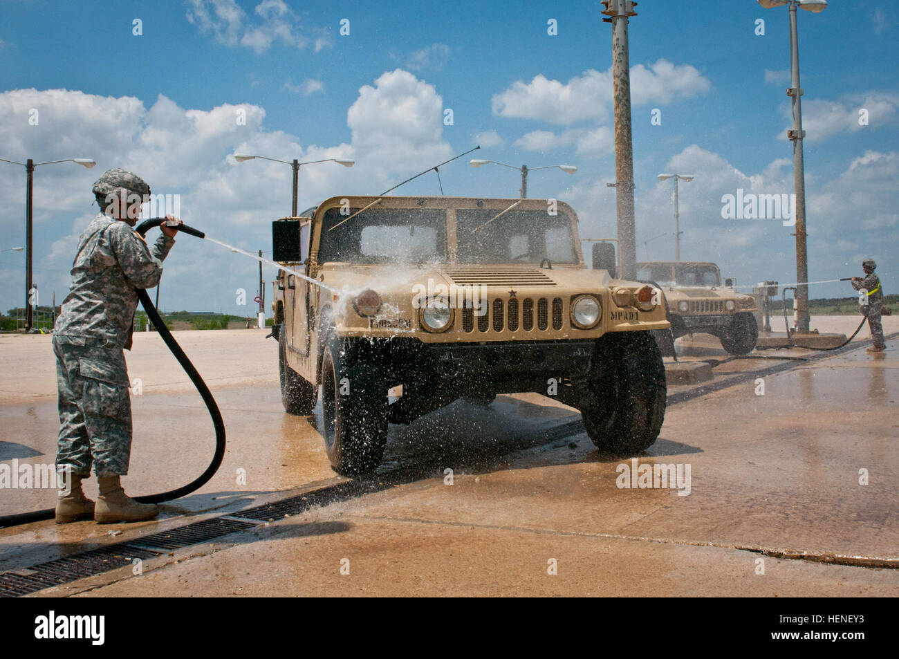 Staff Sgt. Jonathan Concepcion and Sgt. Christal Crawford hose down ...