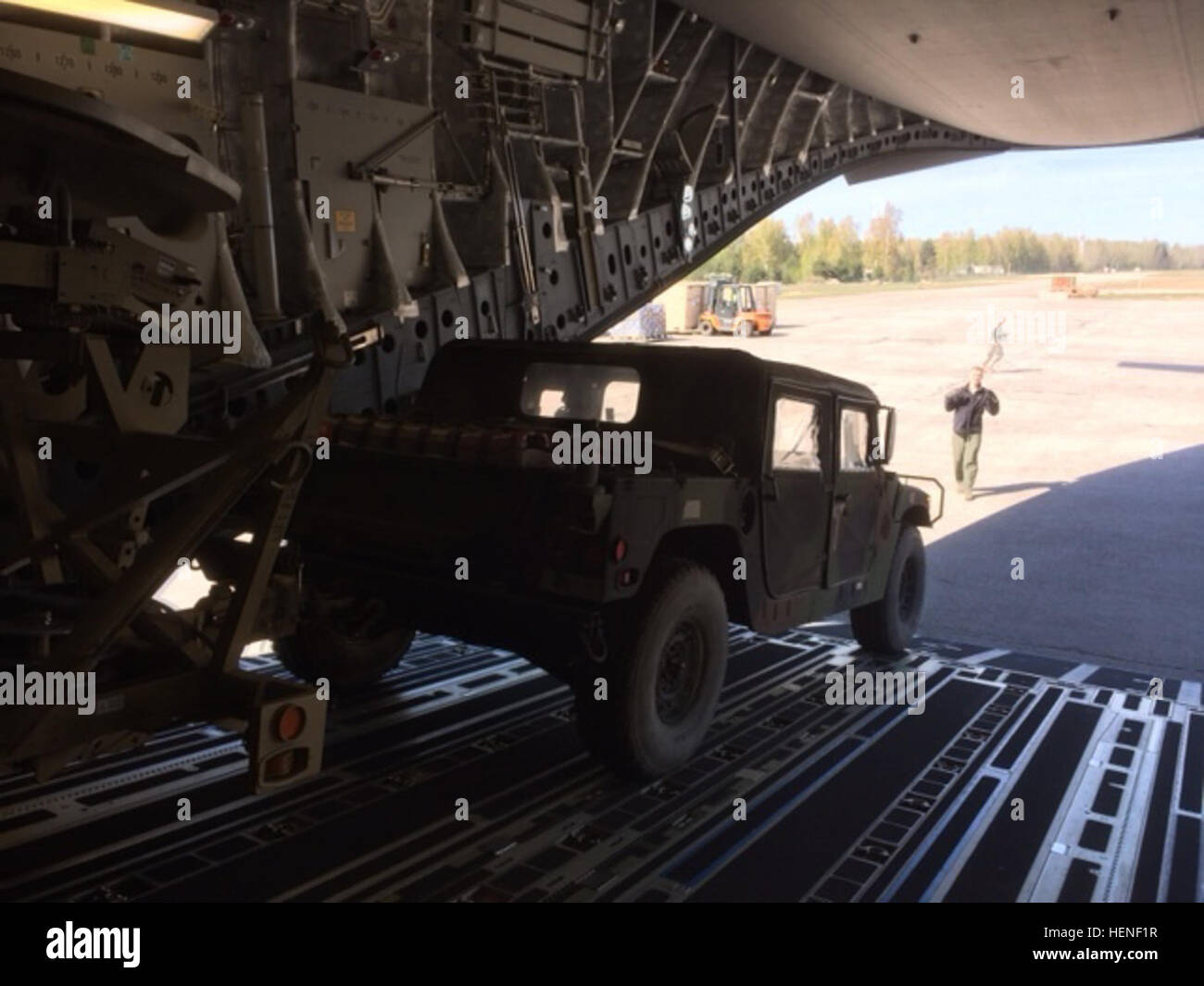 A Humvee is unloaded from a C-17 shortly after the arrival of more than ...