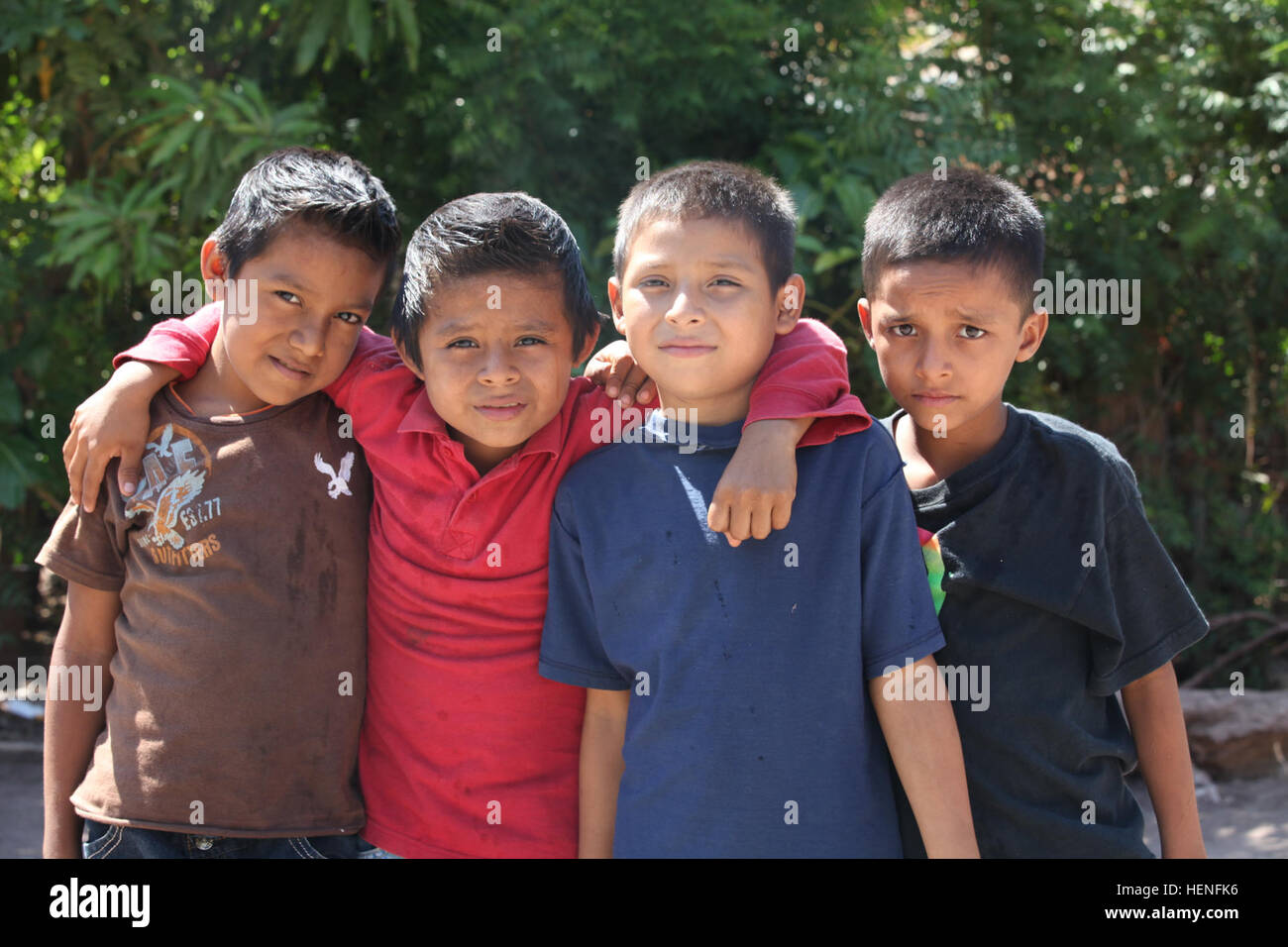 A group of Guatemalan children stand in front of a new clinic being ...