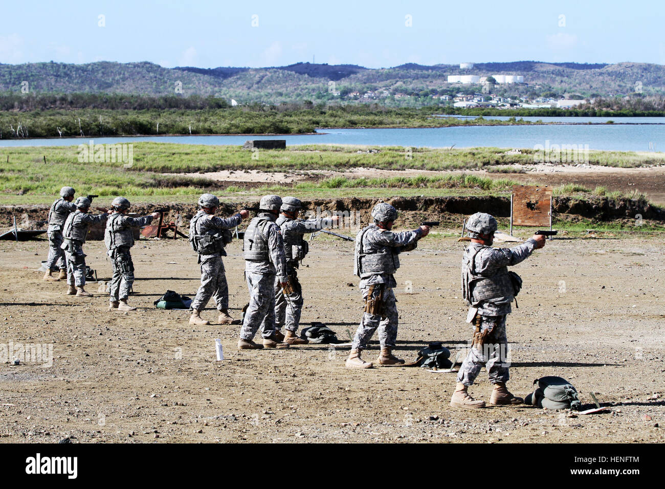 Soldiers line up and take aim at their targets during M9 weapons ...