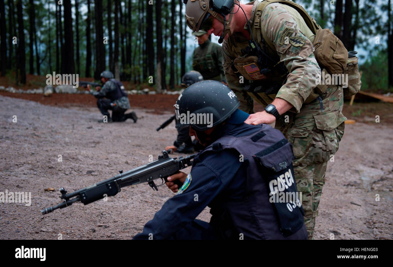A Green Beret inspects the rifle chamber of a TIGRES commando during ...
