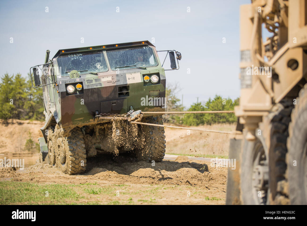 A U.S. Army Palletized Load System M1076 is pulled from a submersion ...