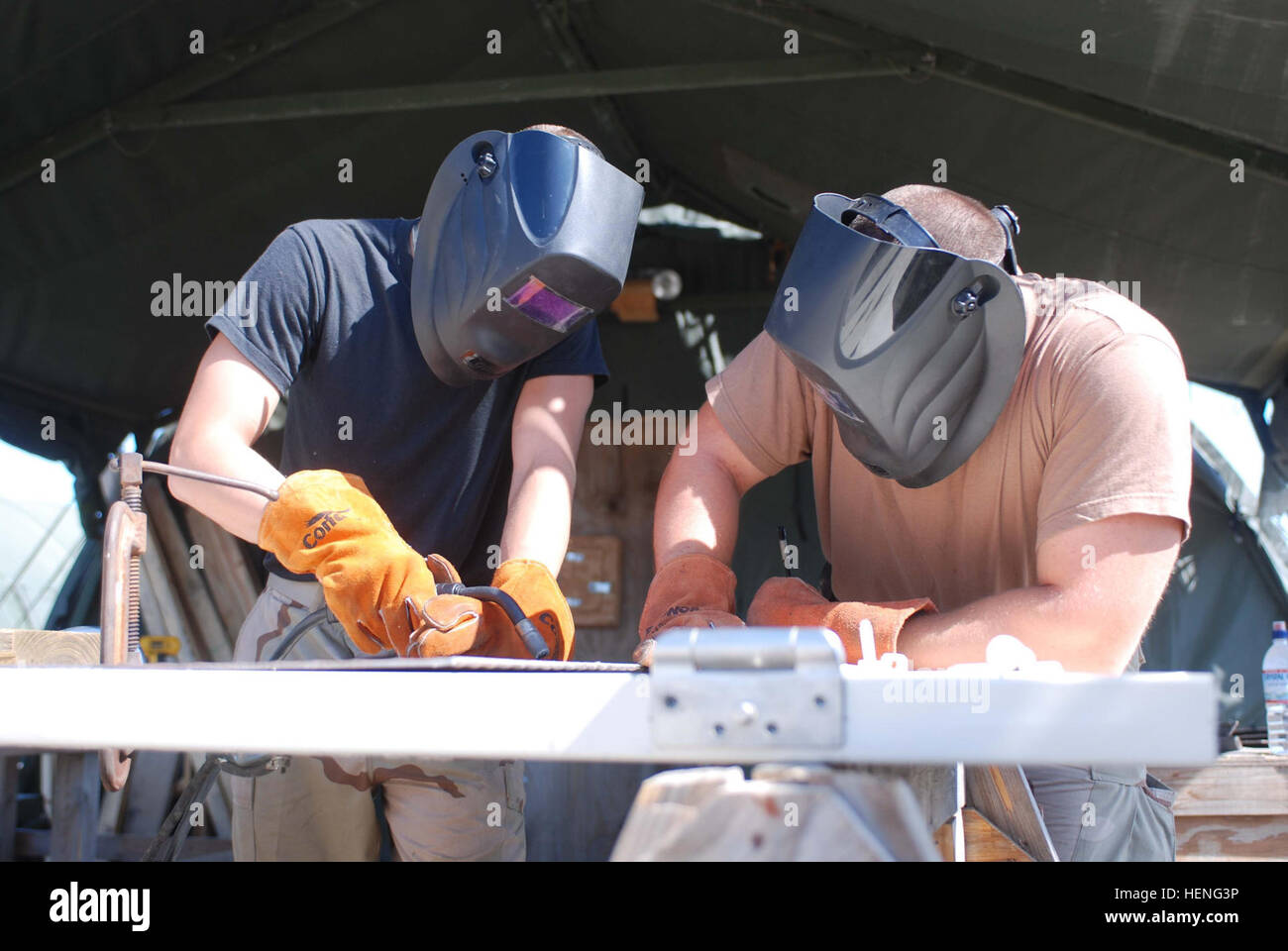 U.S. Air Force personnel weld a detainee cell door at Guantanamo Bay ...