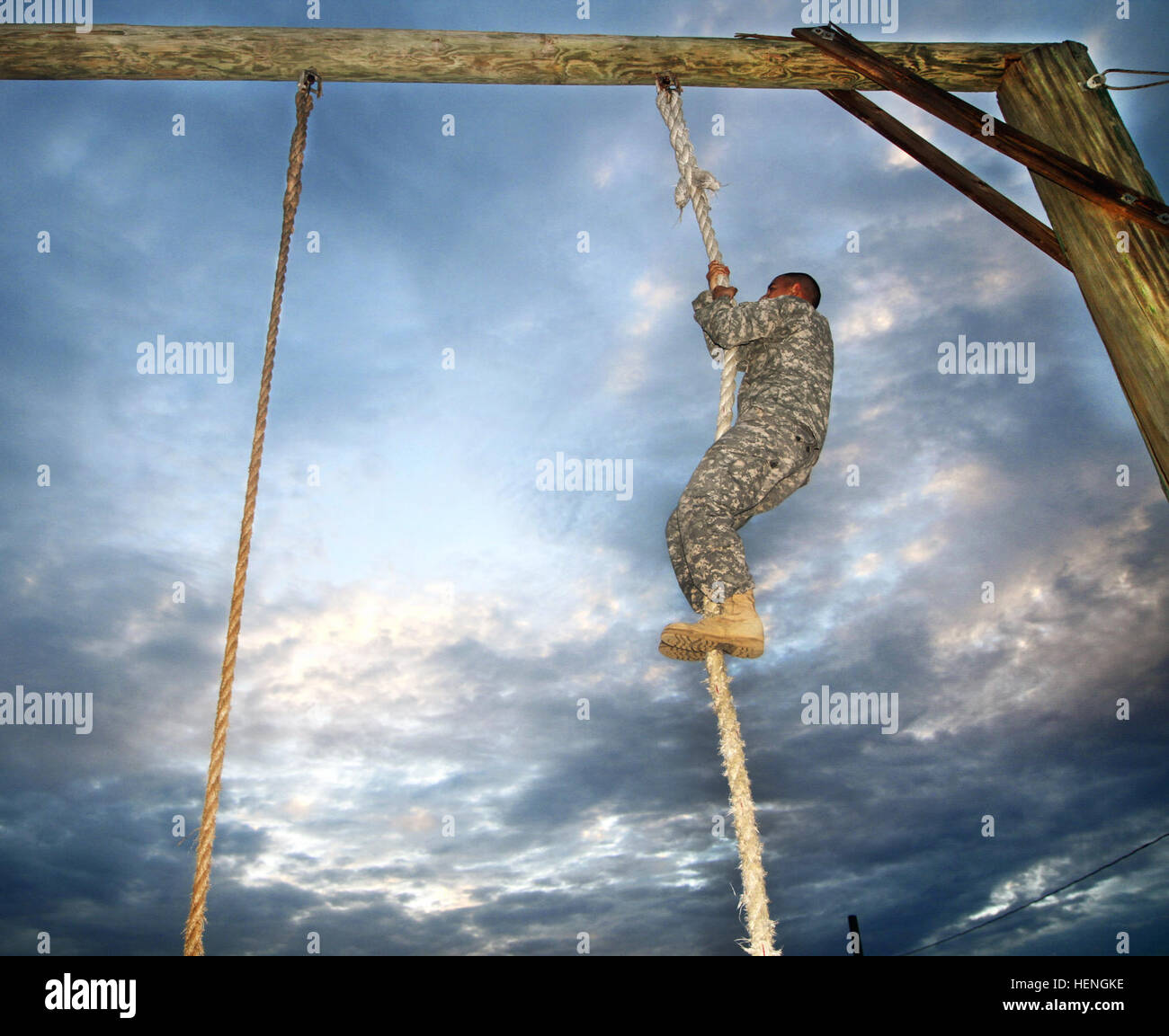 A student pulls himself to the top of the rope climb during the ...