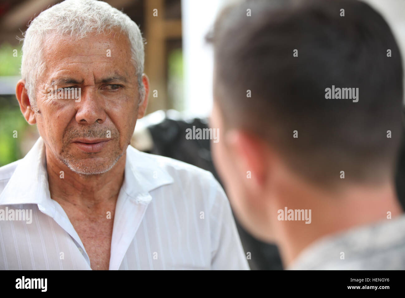 A Guatemalan town leader speaks to a U.S. Army Soldier from the 318th ...