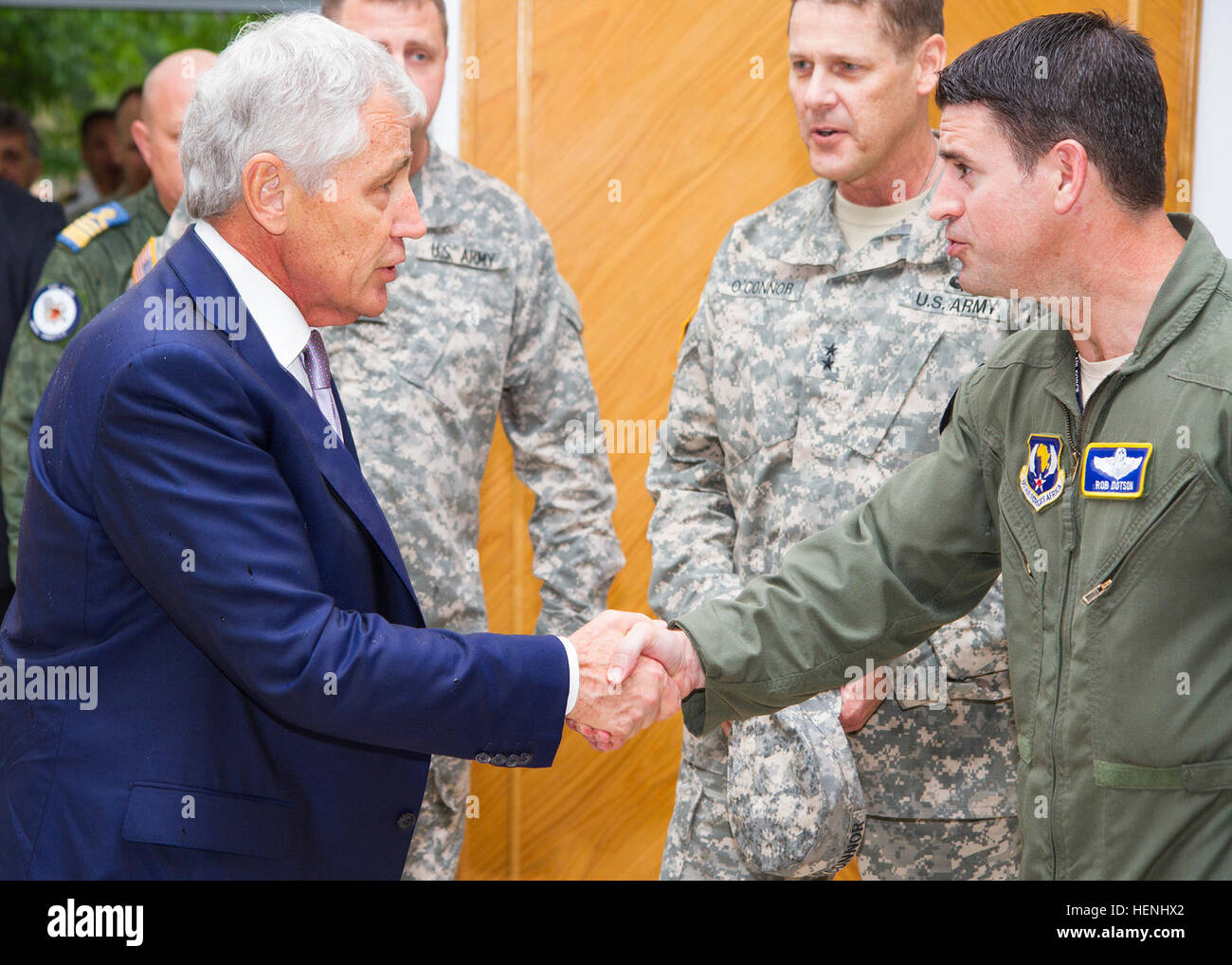 U.S. Secretary of Defense Chuck Hagel greets U.S. Air Force Col. Robert ...