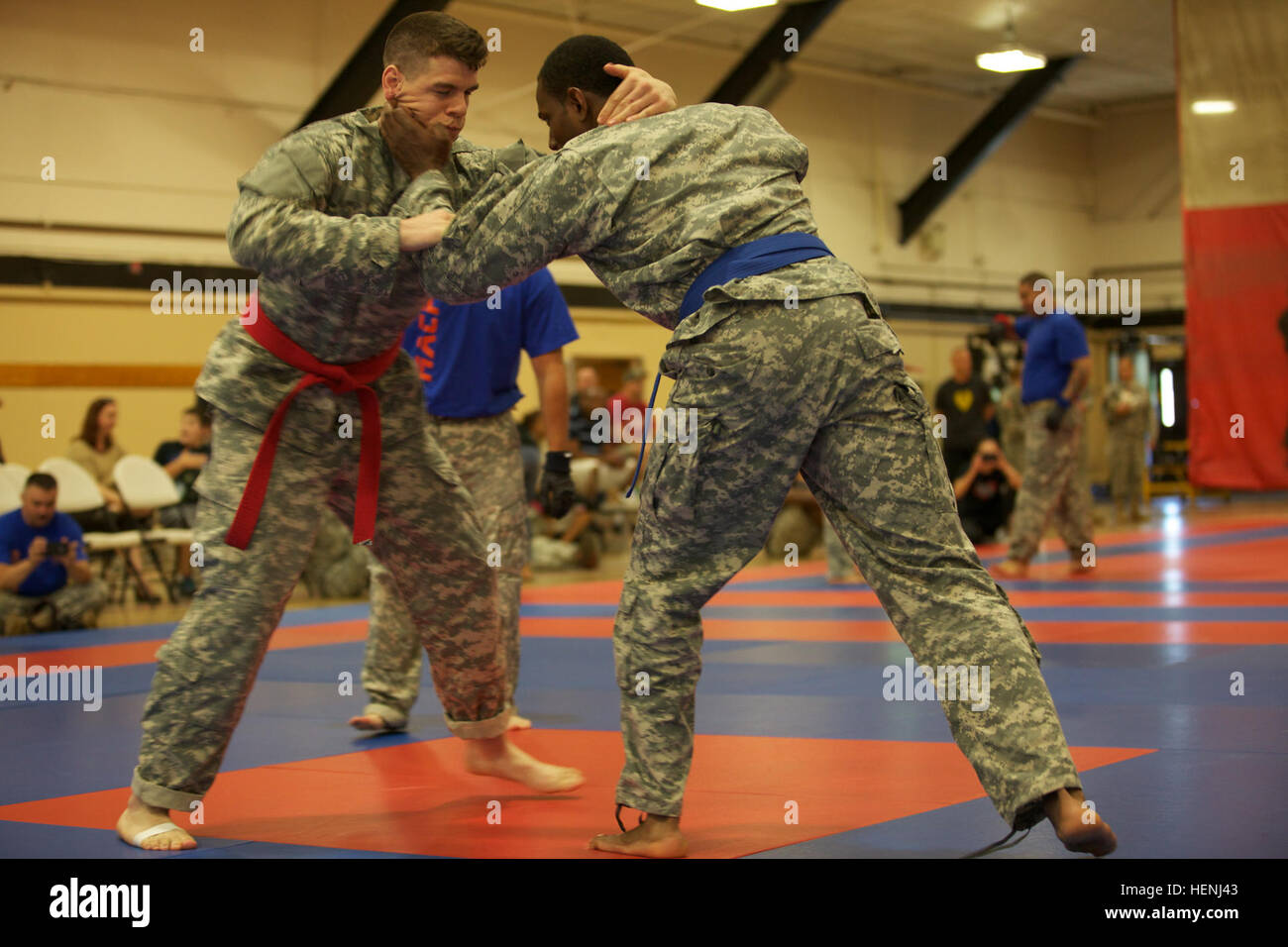 Two U.S. Army Soldiers fight one another while being observed by a ...